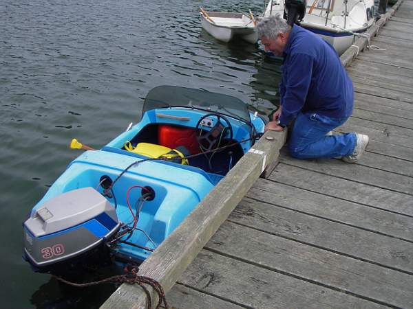 Harvey checking small boat. This has got to be the smallest with the ...